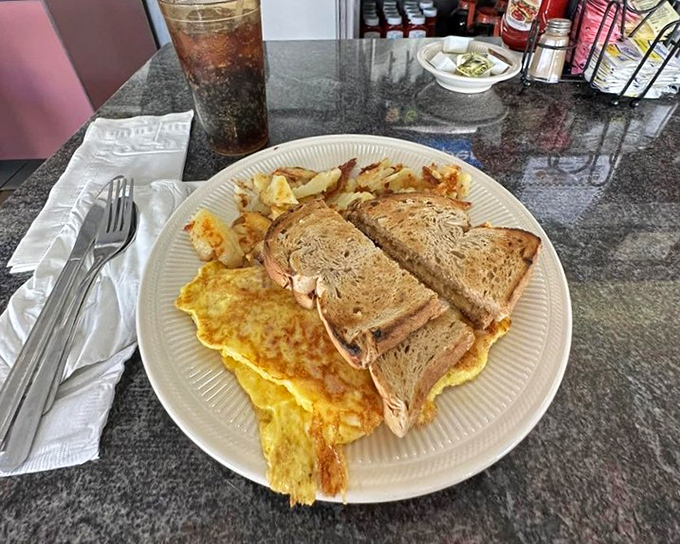 The breakfast sandwich trinity: perfectly toasted bread, fluffy eggs, and those home fries that could make a potato farmer weep with joy.