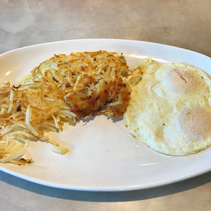 The hash brown and egg duo – a breakfast classic executed with the precision of a culinary symphony.