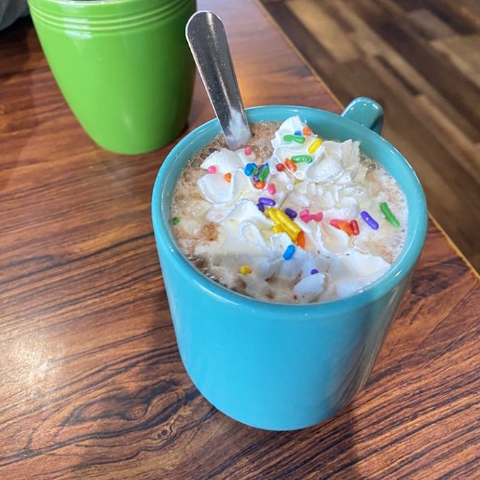 Hot chocolate that doesn't take itself too seriously, topped with whipped cream and rainbow sprinkles. Inner child, activated!