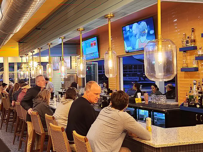 The bar at Red's: where strangers become friends and friends become regulars, all under the glow of perfectly chilled beer signs.