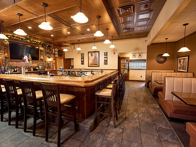 The bar area features warm wood tones, pendant lighting, and comfortable seating that invites you to linger over one more drink.