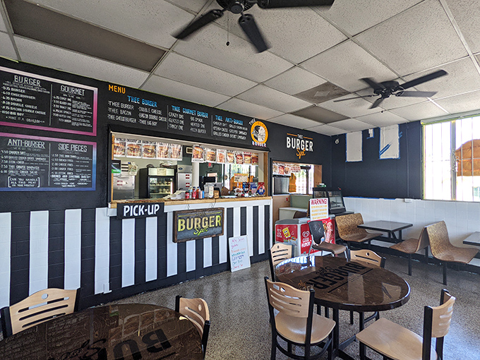 The black and white striped counter gives off retro diner vibes, while the menu boards remind you this is serious burger business.