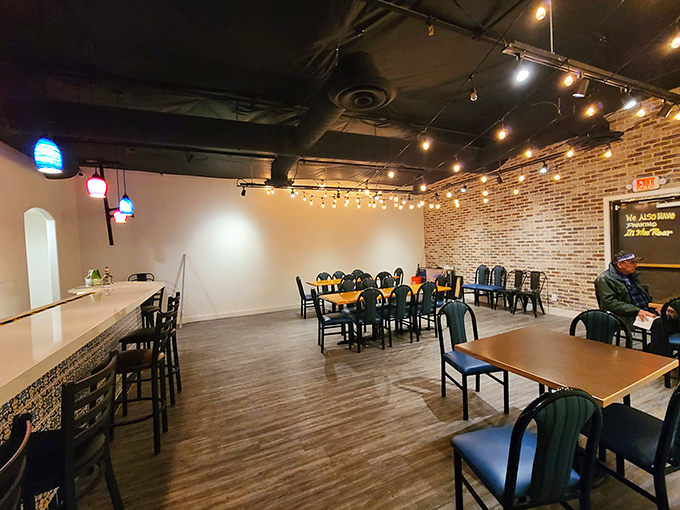 The spacious dining room features exposed brick walls and warm lighting, creating an atmosphere where every meal feels celebratory.
