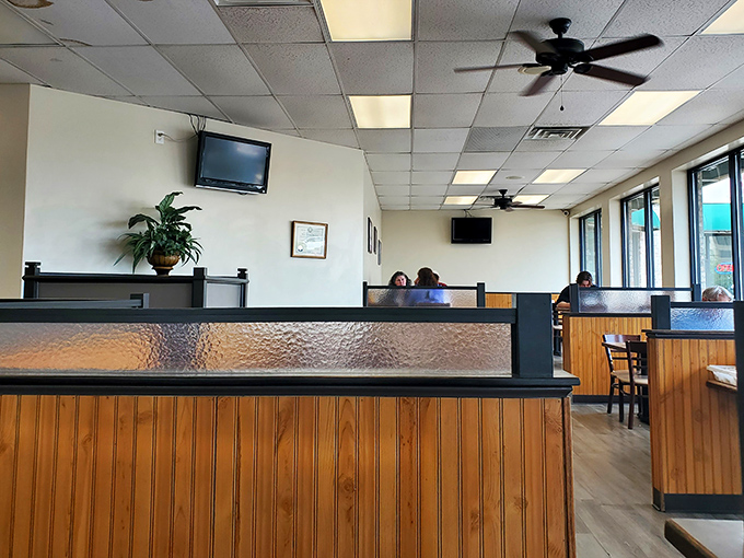 Wood paneling and dividers create cozy dining zones where families can claim their own little territory in this breakfast kingdom.