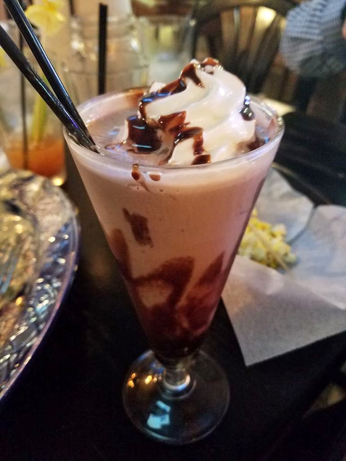 A chocolate shake that's dressed better than most people at the mall. That whipped cream and chocolate drizzle is pure nostalgia in a glass.