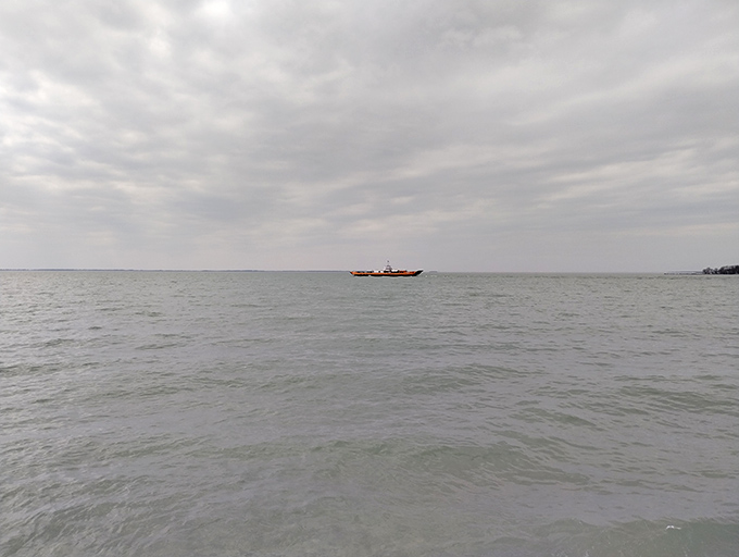 Somewhere out there, a ferry carries new adventurers toward island discoveries. Lake Erie's vastness reminds us we're just passing through.