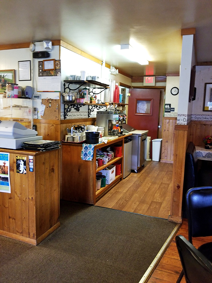 A glimpse into the kitchen where the magic happens, wood paneling and practical shelving speaking to function over flash.