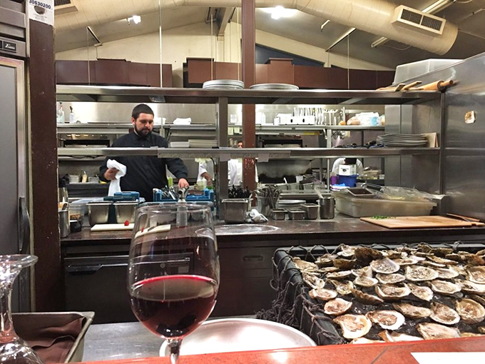 Behind the scenes magic: a glimpse into the kitchen where oysters await their moment of glory and chefs transform ingredients into memories.