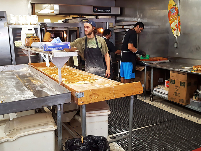 Where the magic happens. Bakers transform simple ingredients into transcendent treats on well-worn wooden workbenches that have witnessed countless dough transformations.