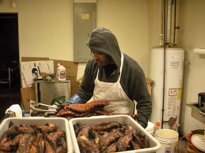 Careful hands preparing a feast. There's artistry in those movements, turning raw ingredients into neighborhood legends.
