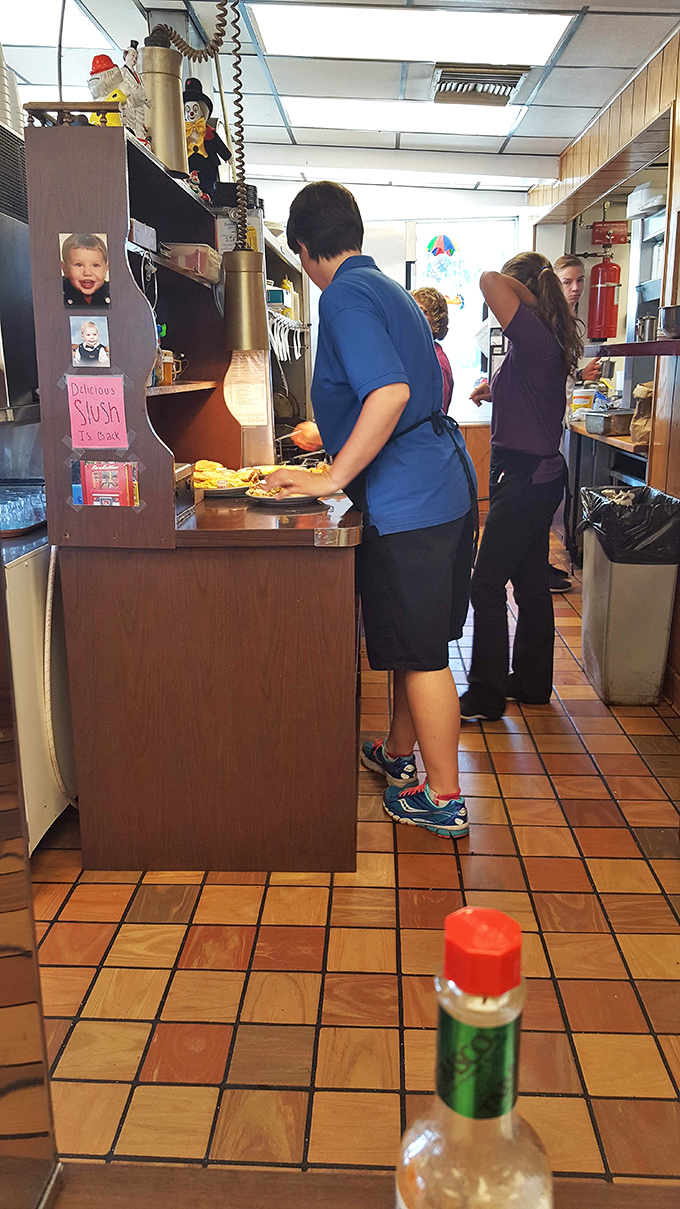 The kitchen ballet&mdash;where orders fly and magic happens. That vintage phone system has probably heard more food orders than a drive-thru speaker in Times Square.
