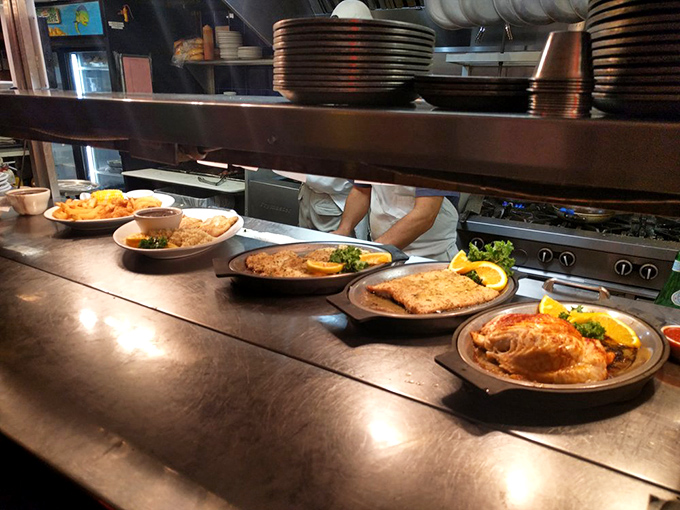 The open kitchen reveals the choreographed dance of turning fresh-off-the-boat catches into platters of seafood perfection.