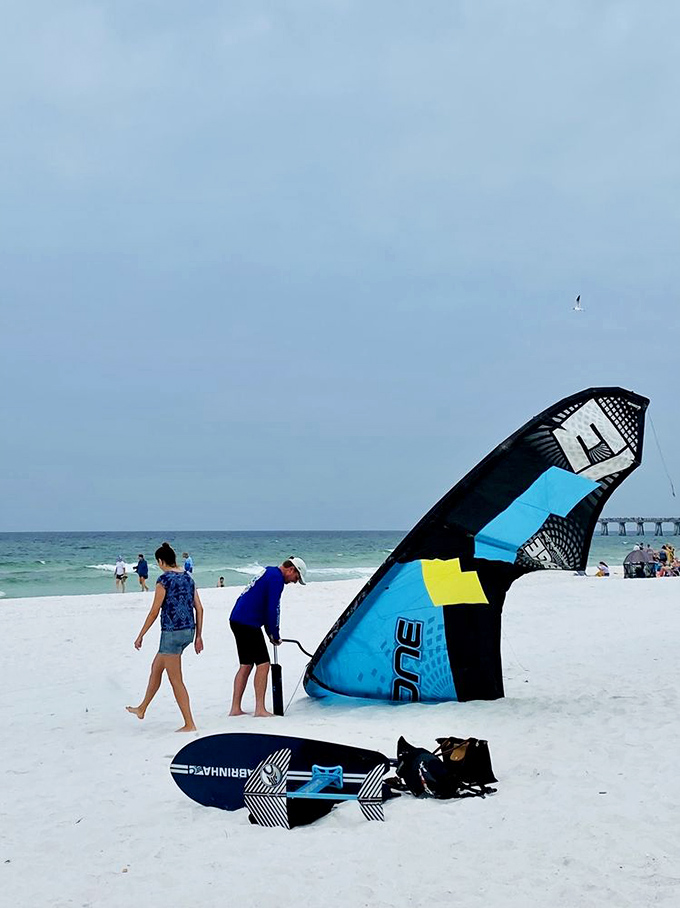 Kiteboarding setup that screams "I'm having more fun than you"—the beach equivalent of bringing a Ferrari to a go-kart track.