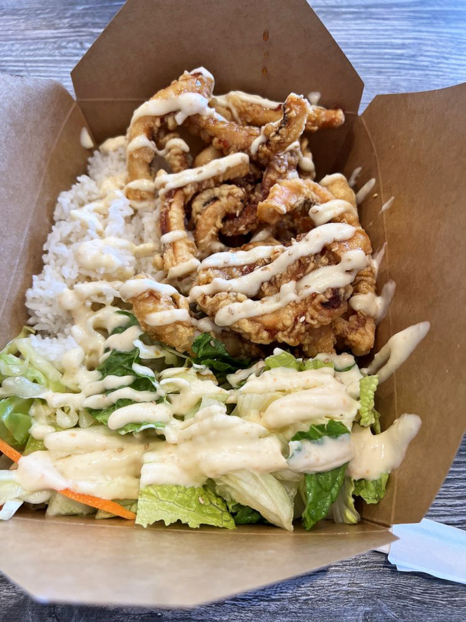A seafood meal displayed in classic paper-boat style, showcasing the democratic approach to dining that makes casual spots like this so endearing.