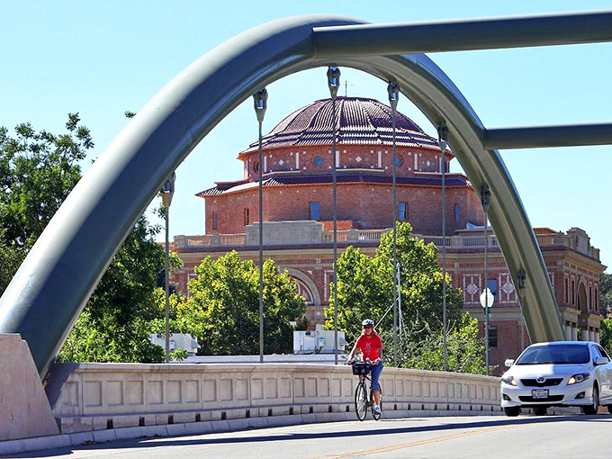 The Lewis Avenue Bridge frames the historic City Hall dome, creating a postcard-perfect scene that cyclists and drivers enjoy daily.