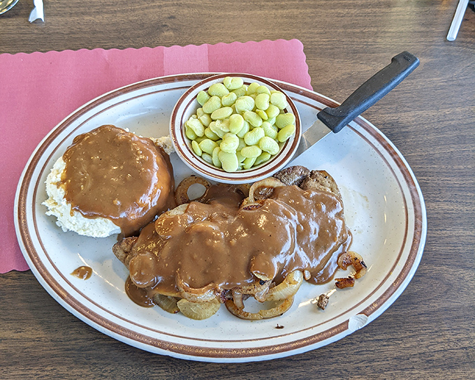 Country cooking that tells a story&mdash;tender liver smothered in gravy with a side of lima beans. This plate screams "I learned to cook from someone who knew what they were doing."