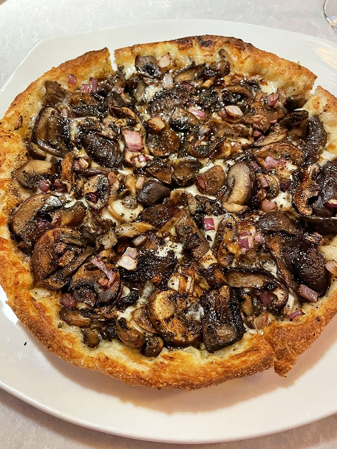 Mushroom pizza elevated to an art form&mdash;caramelized fungi and red onions creating a umami concert on perfectly blistered crust.