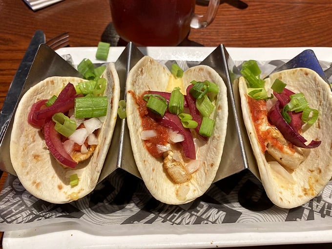 Tacos served in metal holders&mdash;civilization's answer to the age-old question: "How do I keep these delicious fillings from escaping?"