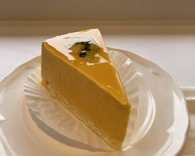 This mango mousse cake doesn't just sit on the plate—it performs a symphony of tropical flavors with the precision of a world-class orchestra.