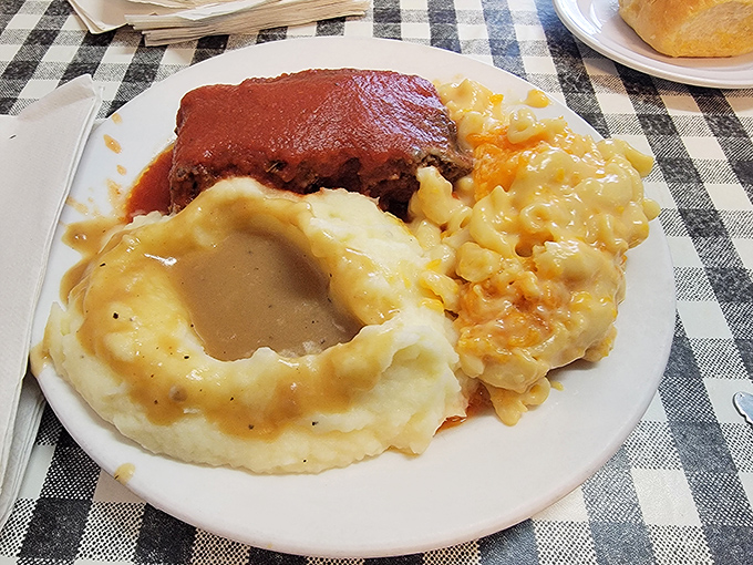 Meatloaf, mashed potatoes with gravy lake, and mac & cheese&mdash;the holy trinity of comfort food that makes Mondays bearable again.