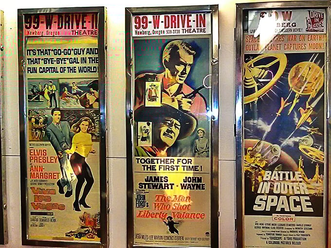 The wall of vintage movie posters reminds us that Elvis, John Wayne, and space battles have all graced this same screen across decades.