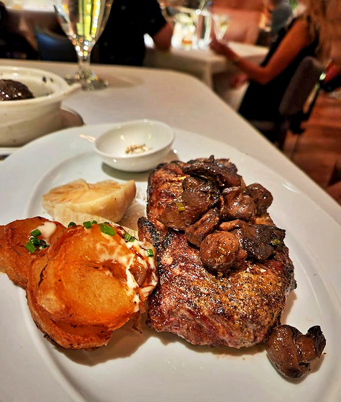A steak that's clearly been taking its iron supplements, flanked by mushrooms that found their life's purpose beside this magnificent meat.