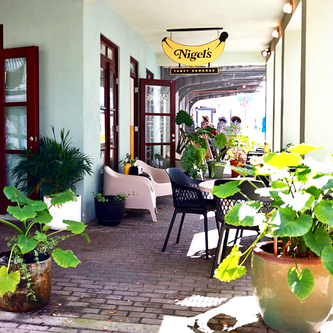 Nigel's Bananas surrounds visitors with lush greenery and casual seating. The kind of porch where one coffee easily turns into three hours of people-watching.