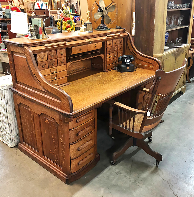 This isn't just a desk&mdash;it's command central for the 1920s professional. More drawers than a department store and twice the character.
