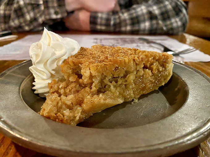 The legendary Oatmeal Pie with a dollop of whipped cream&mdash;proof that sometimes the most unassuming desserts deliver the most memorable finales.