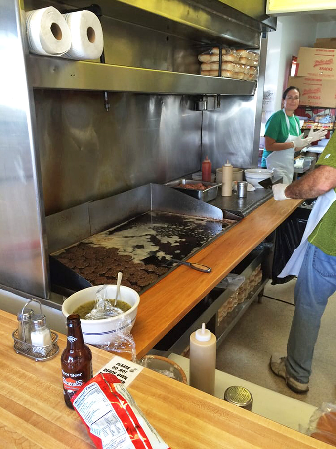 The well-seasoned flat-top grill—where the magic happens. Decades of burger-making have seasoned this cooking surface better than any chef ever could.