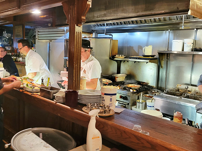 The open kitchen reveals the choreography behind the culinary magic. No smoke and mirrors here&mdash;just skilled hands crafting seafood perfection.
