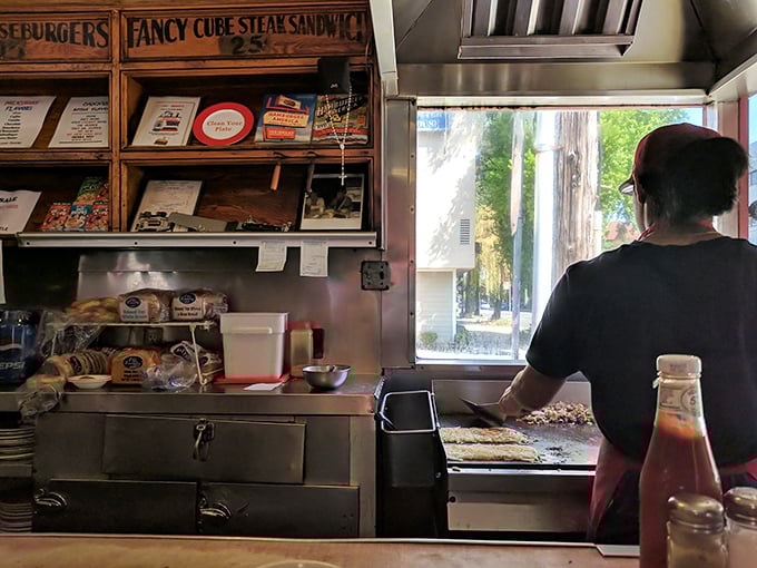 The open kitchen isn't about trendy transparency—it's tradition, allowing you to witness the choreographed dance of short-order cooking.
