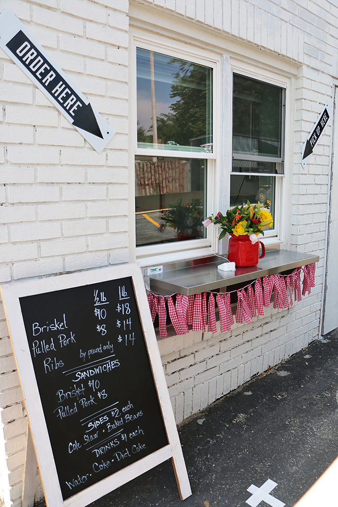 The ordering window, dressed up with red-checkered curtains, where dreams are spoken aloud and emerge minutes later as smoky reality.
