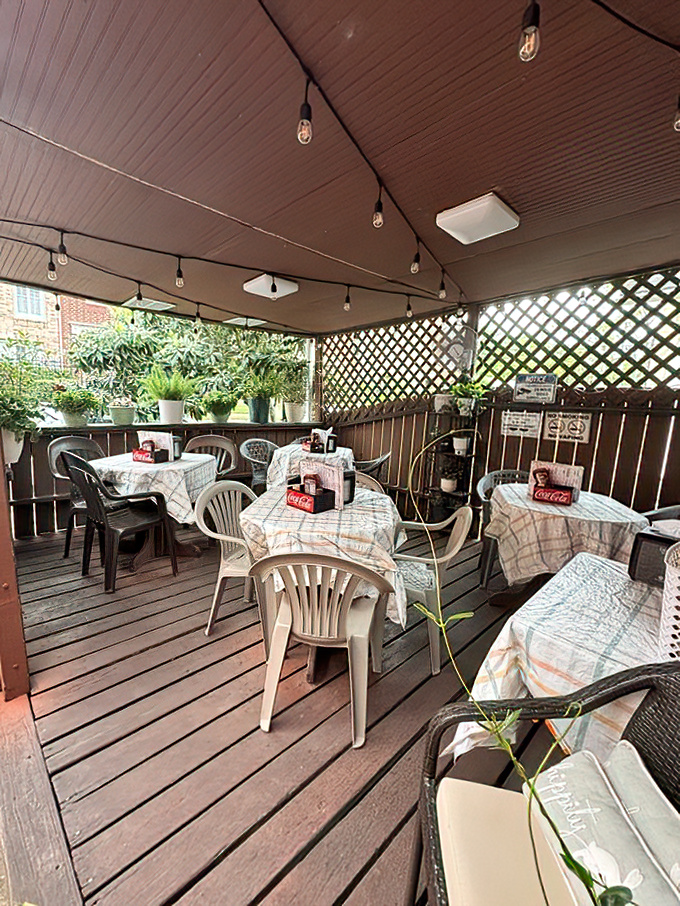 The covered patio offers a more intimate dining experience, where checkered tablecloths and Coca-Cola napkin holders set the unpretentious stage.
