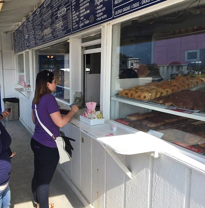 The display case of donuts behind the counter is like a museum of edible art, with customers lining up to take home their favorite masterpieces.