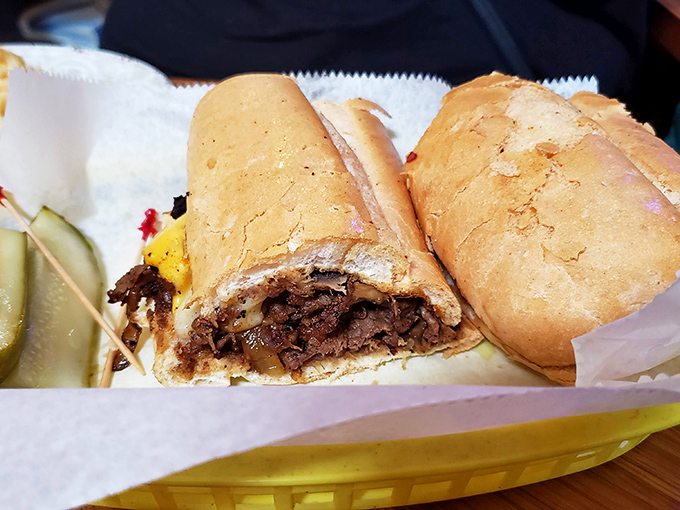 A Philly cheesesteak that would make Rocky climb those steps again, nestled in a basket with a pickle that knows its supporting role.