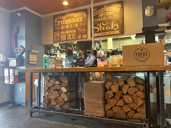 Stacked firewood reveals the secret behind those incredible flavors&mdash;real wood, real smoke, real barbecue that respects tradition and your taste buds equally.