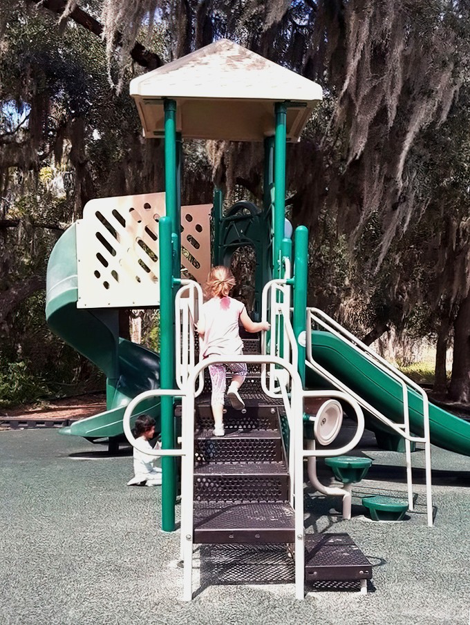 Even in wilderness, kids need to climb. This playground nestled among Spanish moss-draped trees blends outdoor play with natural surroundings.