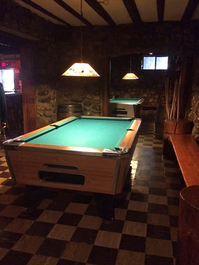 The checkerboard floor leads to vintage pool tables where friendly competitions unfold beneath stained glass lamps, proving Legs Inn knows how to entertain beyond just feeding you well.