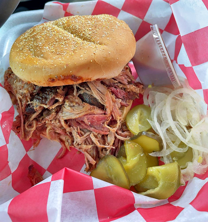 This pulled pork sandwich isn't just a meal&mdash;it's an achievement. The pickles and onions add the perfect tangy contrast to the smoky meat.