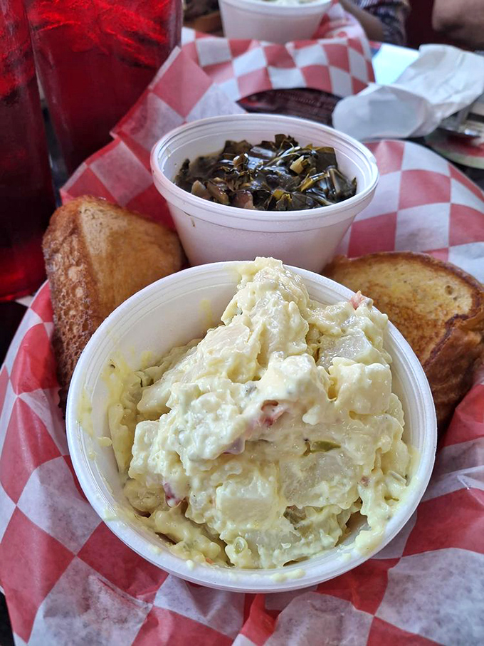Potato salad and collard greens nestled beside golden toast&mdash;the supporting actors that deserve their own standing ovation in this culinary performance.