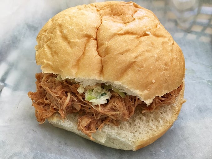 BBQ pulled chicken on a soft bun&mdash;proof that sometimes the messiest foods are the ones most worth the napkin investment. 