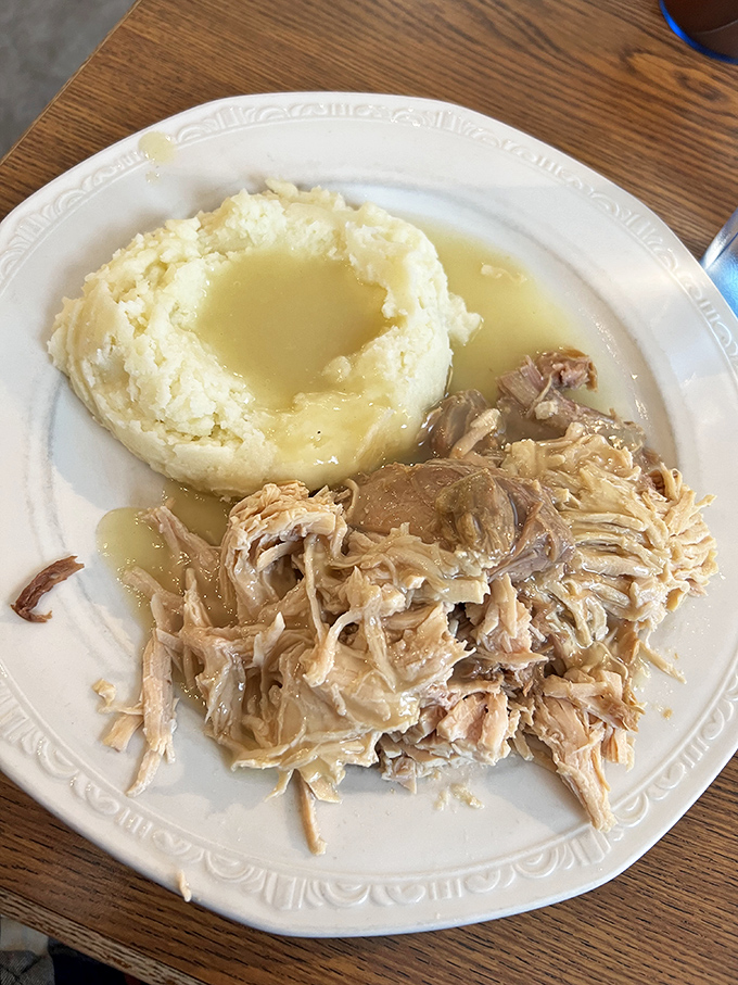 Pulled pork and mashed potatoes swimming in gravy&mdash;a plate that whispers, "Nap time soon." Comfort food that delivers on its promise.