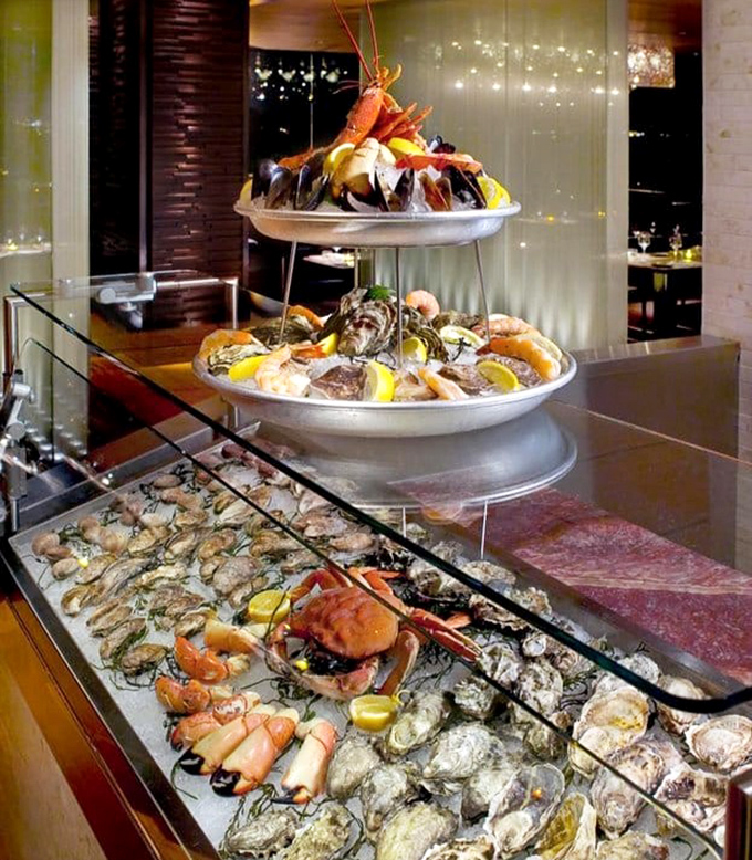 The seafood tower that makes grown adults gasp like children on Christmas morning. Neptune's gift basket arranged with such precision it feels almost criminal to disturb its beauty.