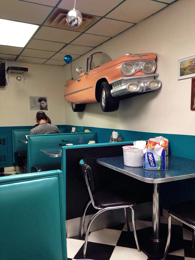 That classic car bursting through the wall adds just the right touch of whimsical Americana to your meal.