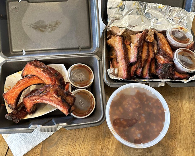 Ribs that make you reconsider your stance on public displays of affection. Two sauce cups because one flavor dimension simply isn't enough.