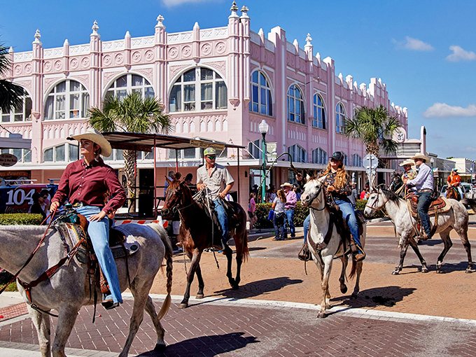 Rodeo cowboys parade past the iconic pink Opera House, blending Florida's architectural heritage with its surprisingly robust Western traditions.
