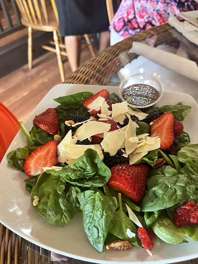 A salad that doesn't feel like punishment. Fresh spinach, strawberries, and shaved parmesan create a symphony of flavors that even confirmed carnivores will appreciate. 