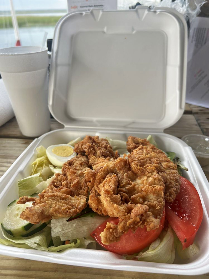 A crispy chicken salad that proves even the land-based options deserve your attention at this seafood sanctuary.