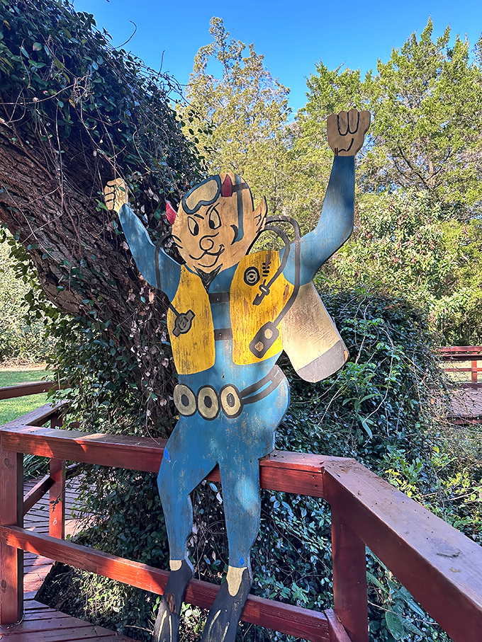 The unofficial mascot of Devil's Den stands guard. This cheerful diver has been welcoming visitors longer than most staff.